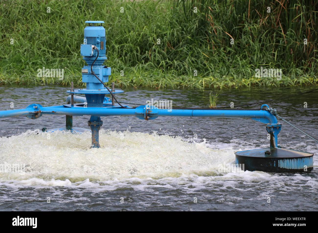 Water treatment by adding oxygen to the water using a propeller to hit ...