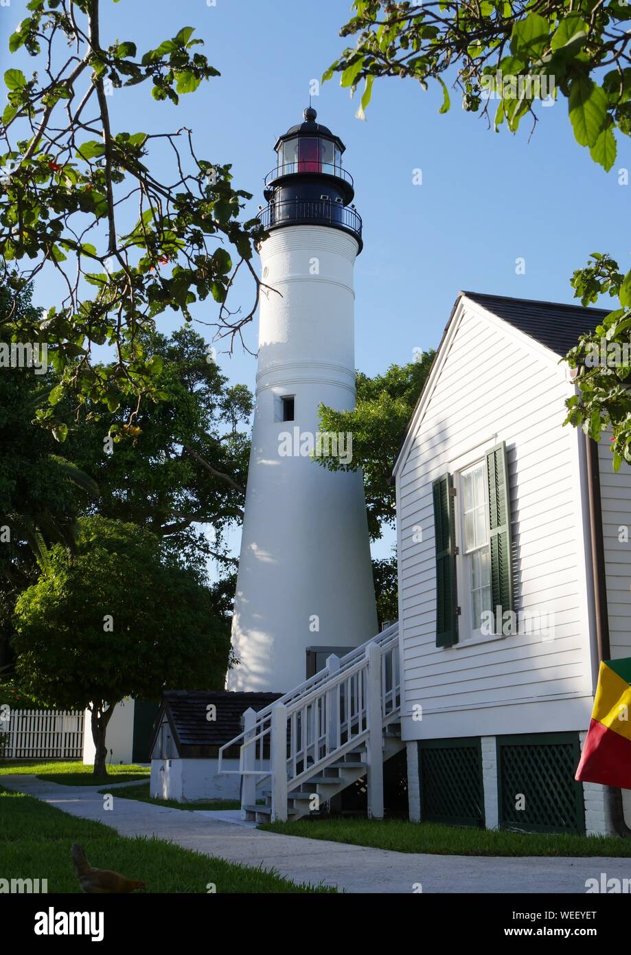 Portrait view of the lighthouse with the keeper's quarters at Key West ...