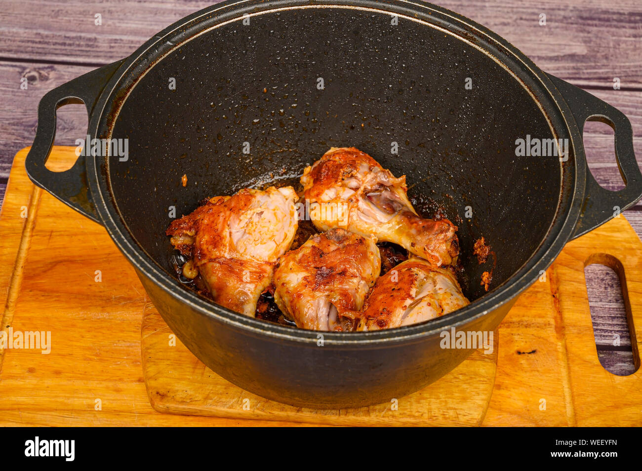 Chicken legs marinated with spices are fried in a cauldron Stock Photo ...