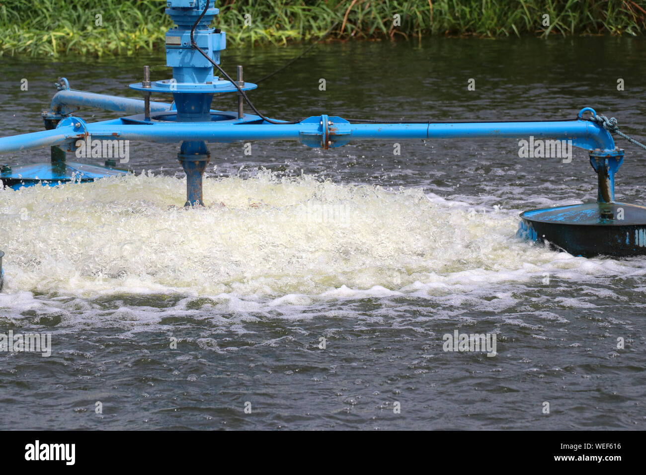 Water treatment by adding oxygen to the water using a propeller to hit ...