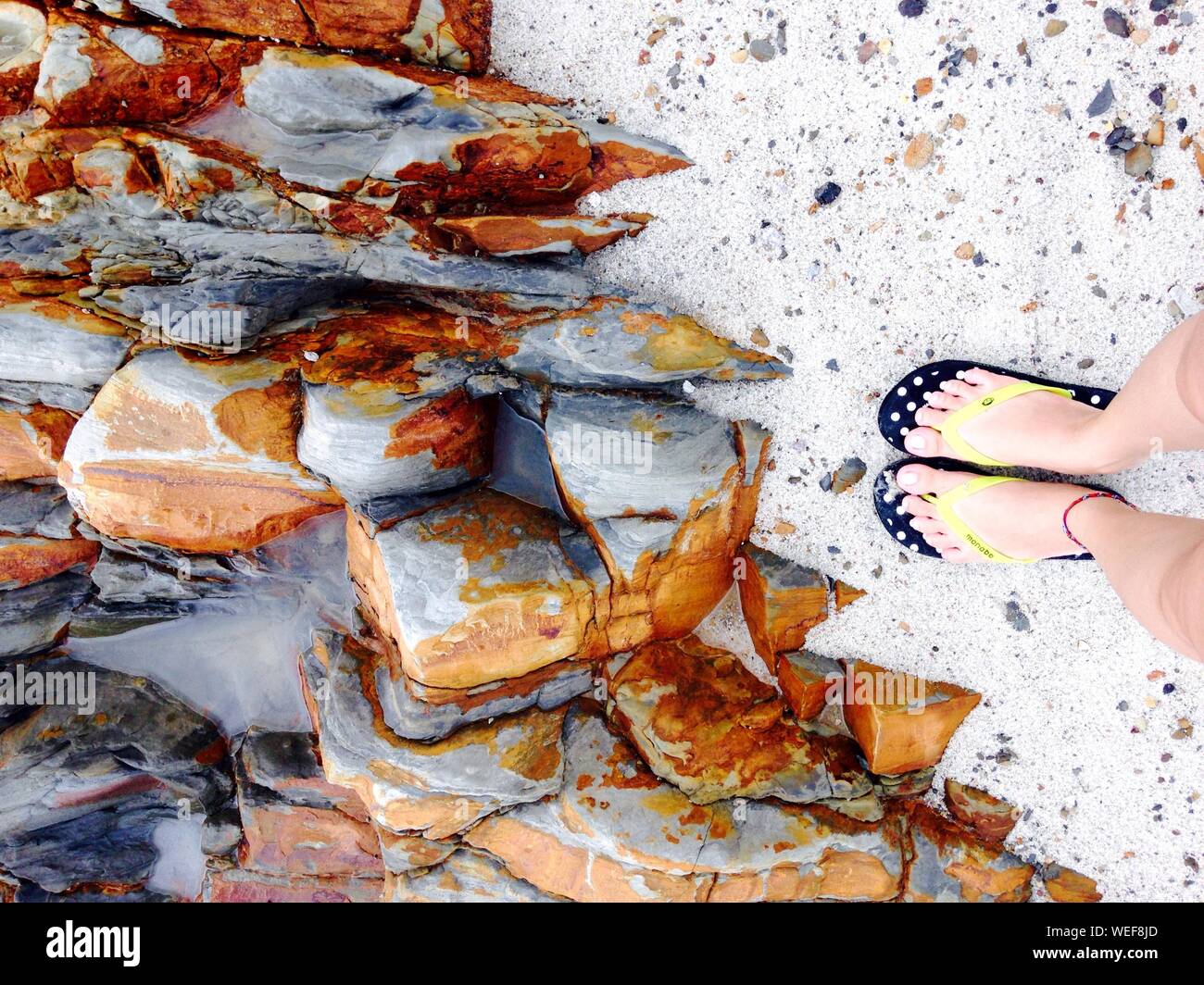 Woman rocks beach hi-res stock photography and images - Alamy