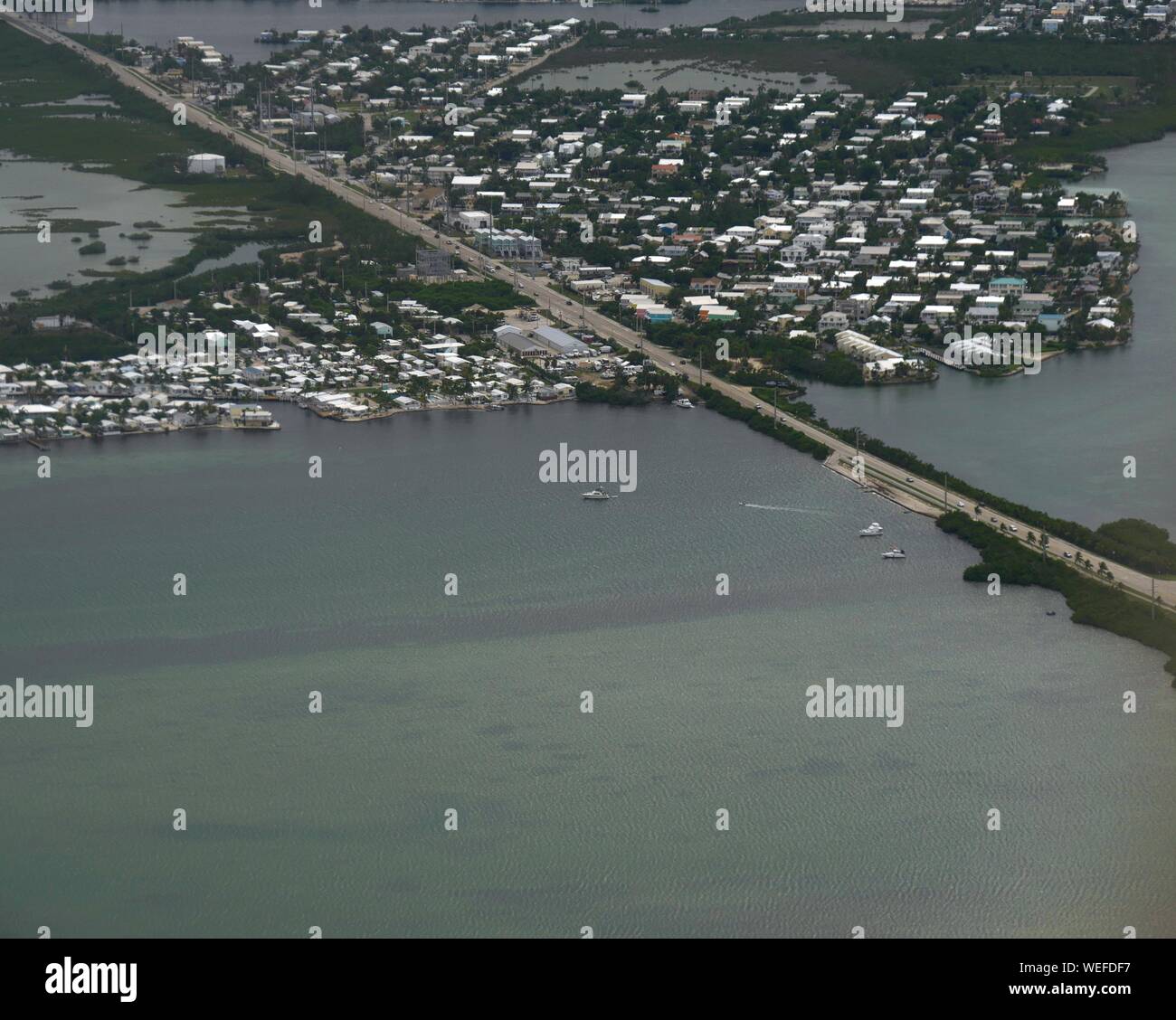 Aerial view of Key West with the US Highway 1, seen from an airplane ...
