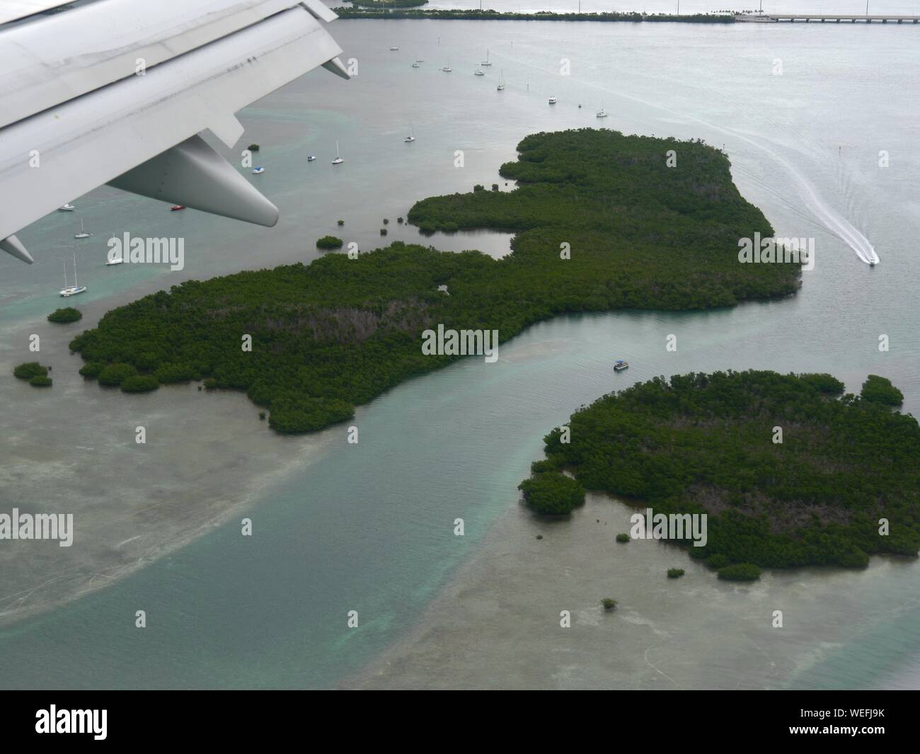 Aerial view of the Florida Keys with an airplane wing in view Stock ...