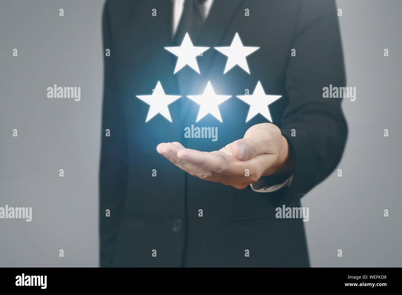 Hand touching five star symbol to increase rating of company concept ...