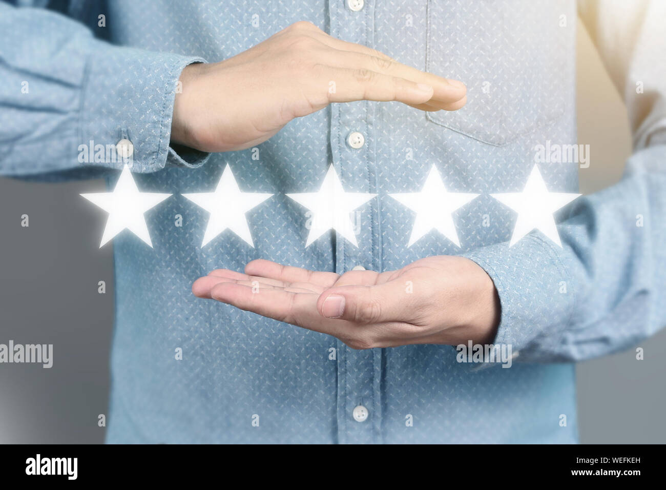 Hand touching five star symbol to increase rating of company concept ...