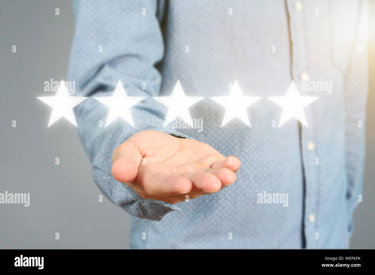 Hand touching five star symbol to increase rating of company concept ...