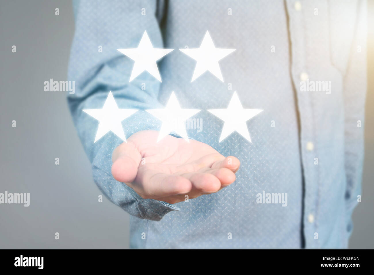 Hand touching five star symbol to increase rating of company concept ...