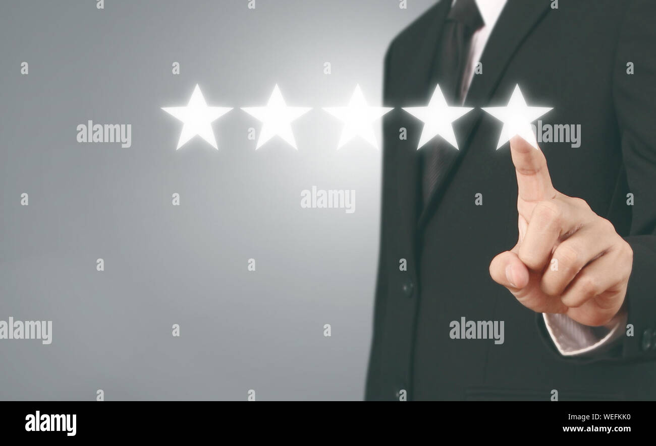 Hand touching five star symbol to increase rating of company concept ...