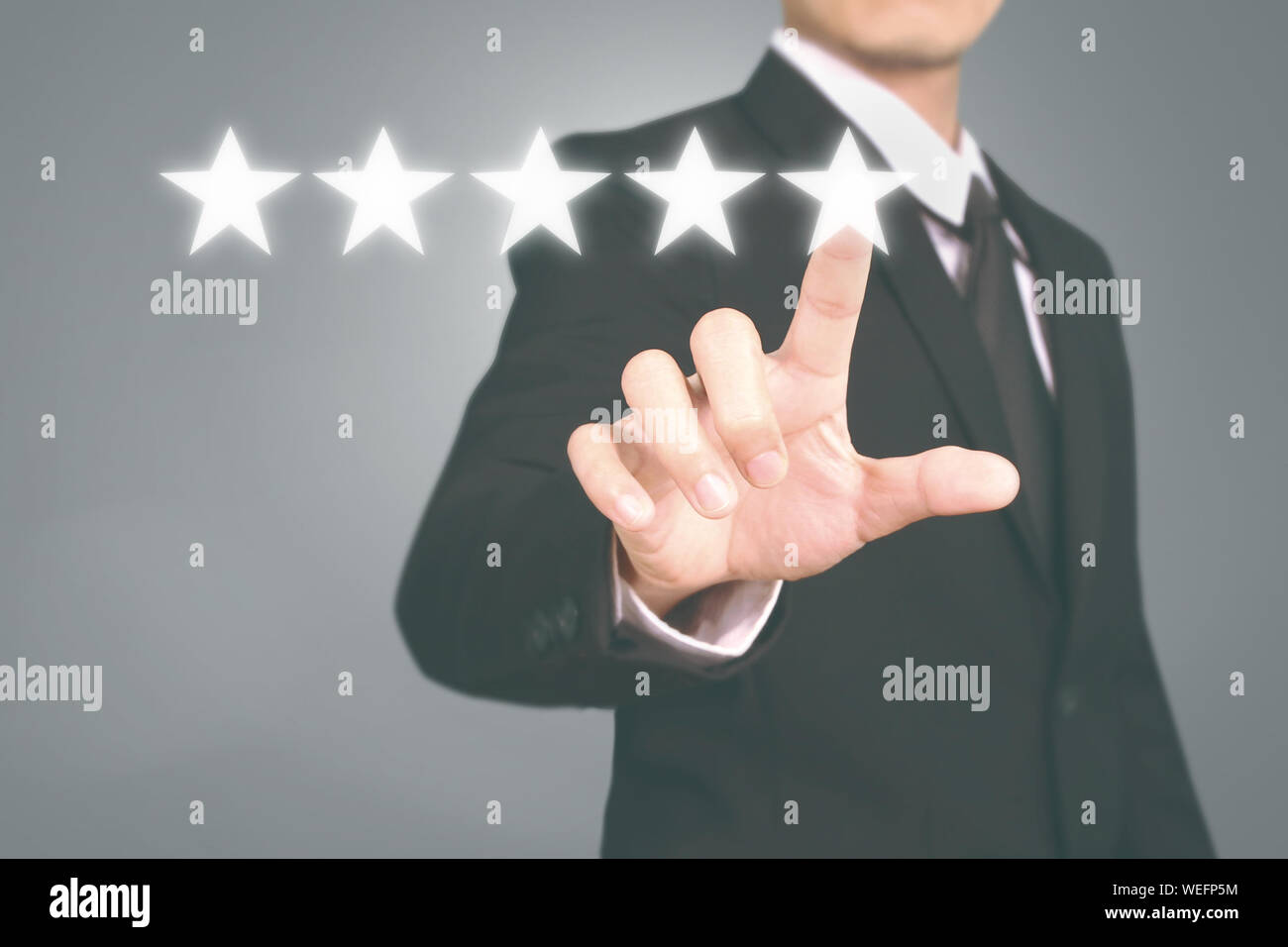 Hand touching five star symbol to increase rating of company concept ...