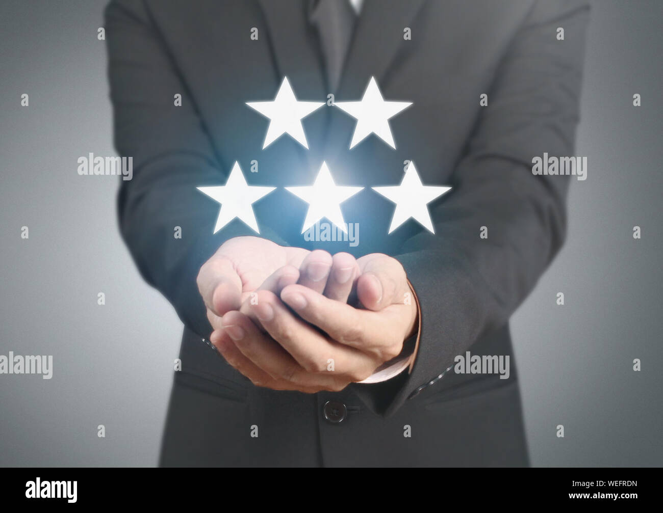Hand touching five star symbol to increase rating of company concept ...