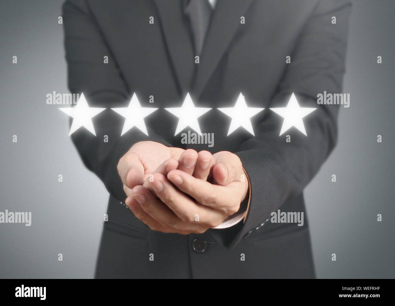 Hand touching five star symbol to increase rating of company concept ...