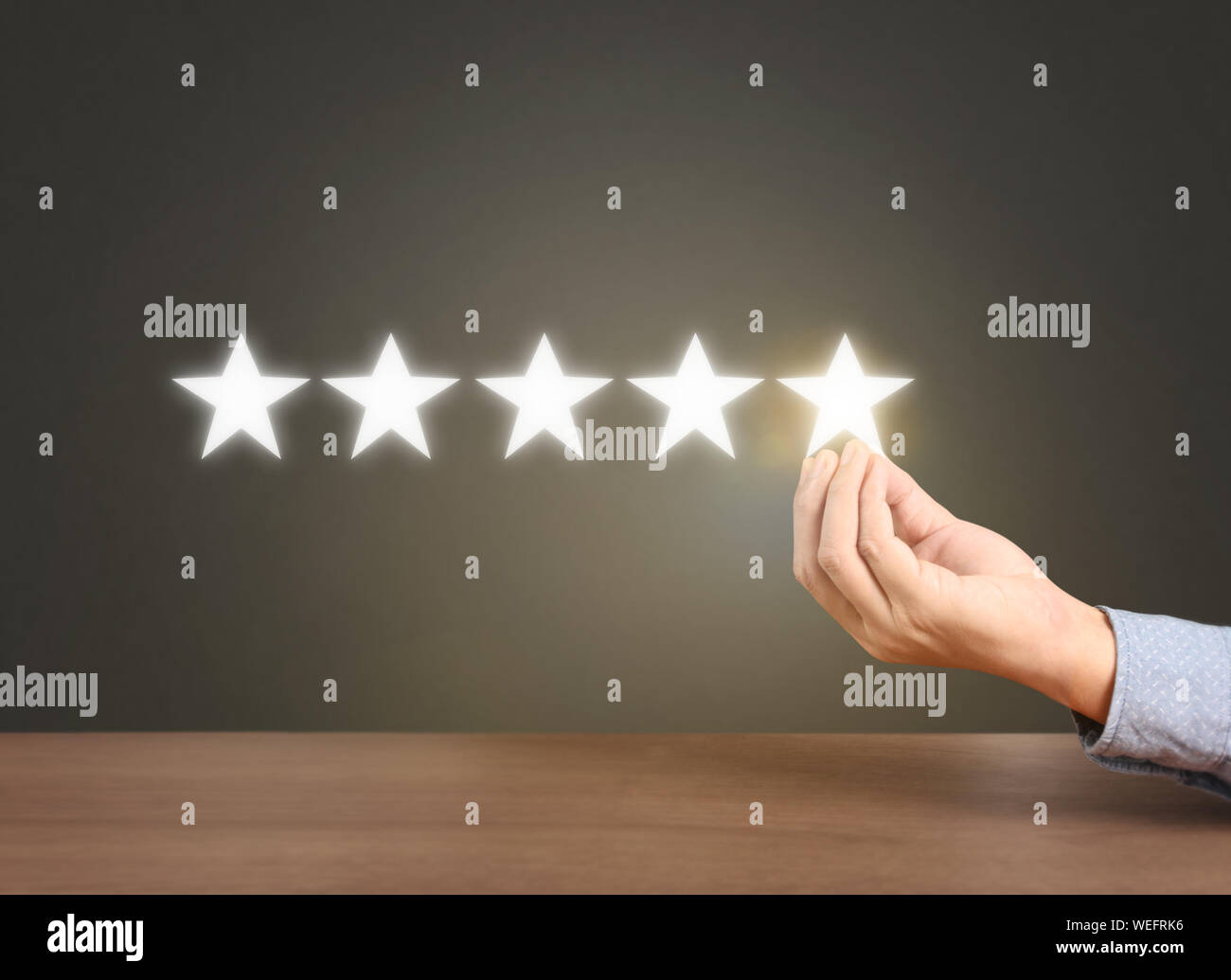 Hand touching five star symbol to increase rating of company concept ...