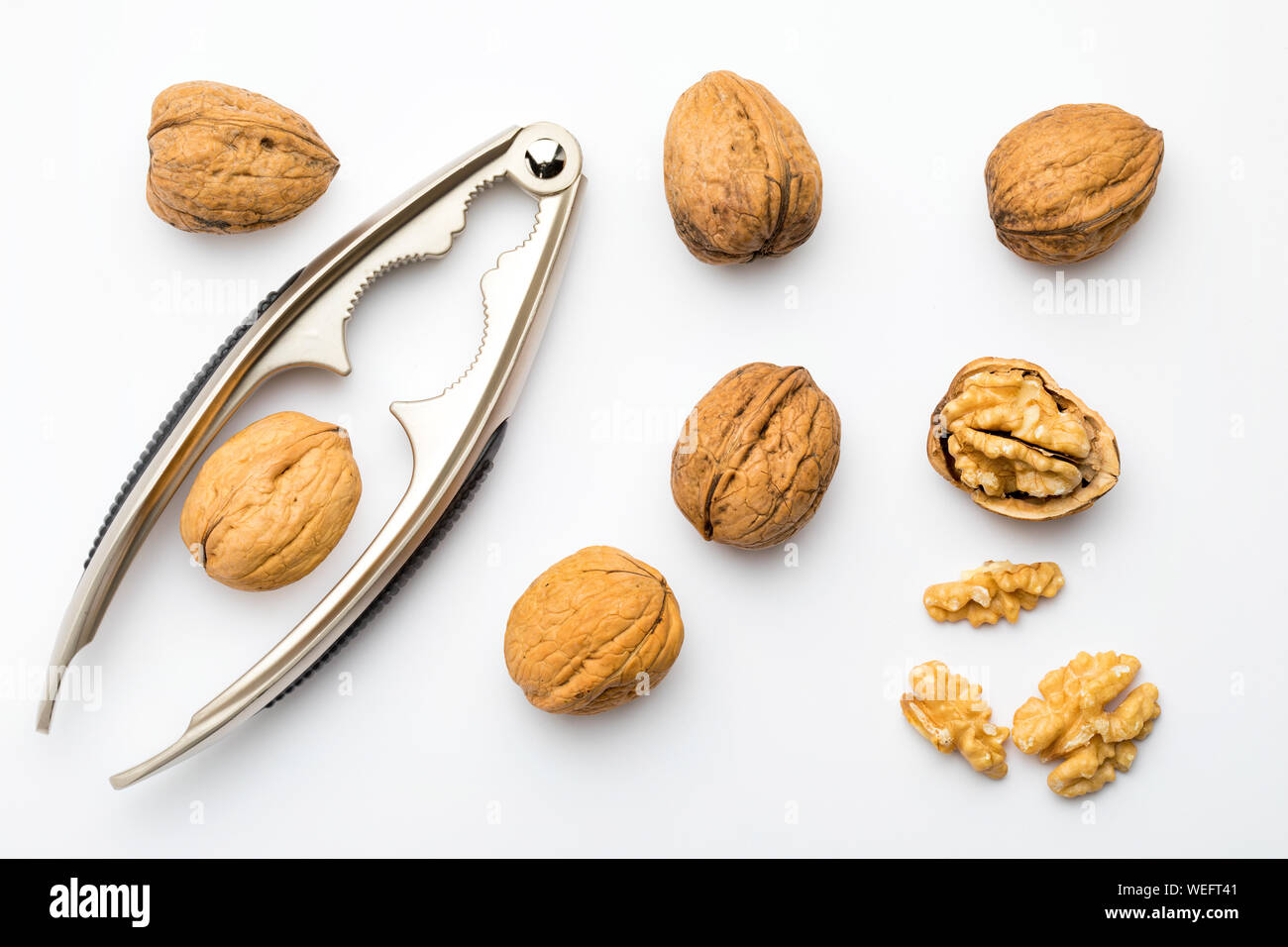 Nuts (whole and open) with cascador. Isolated on white background Stock ...