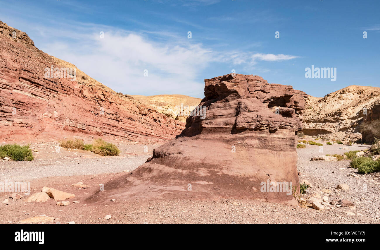 a giant sandstone boulder sits in the middle of wadi shani at the ...