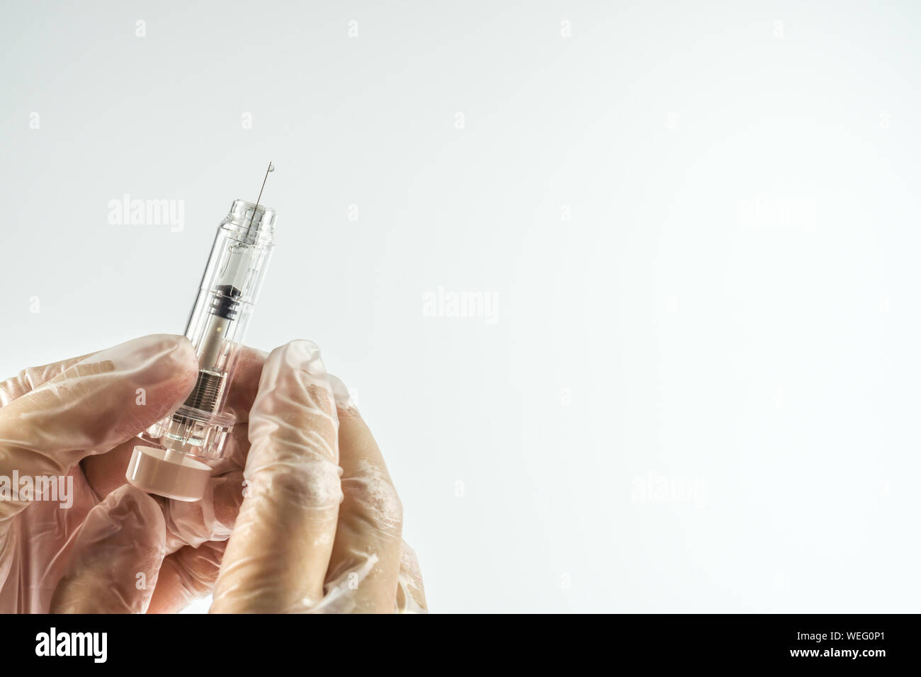 Close up hand holding syringe hi-res stock photography and images - Alamy