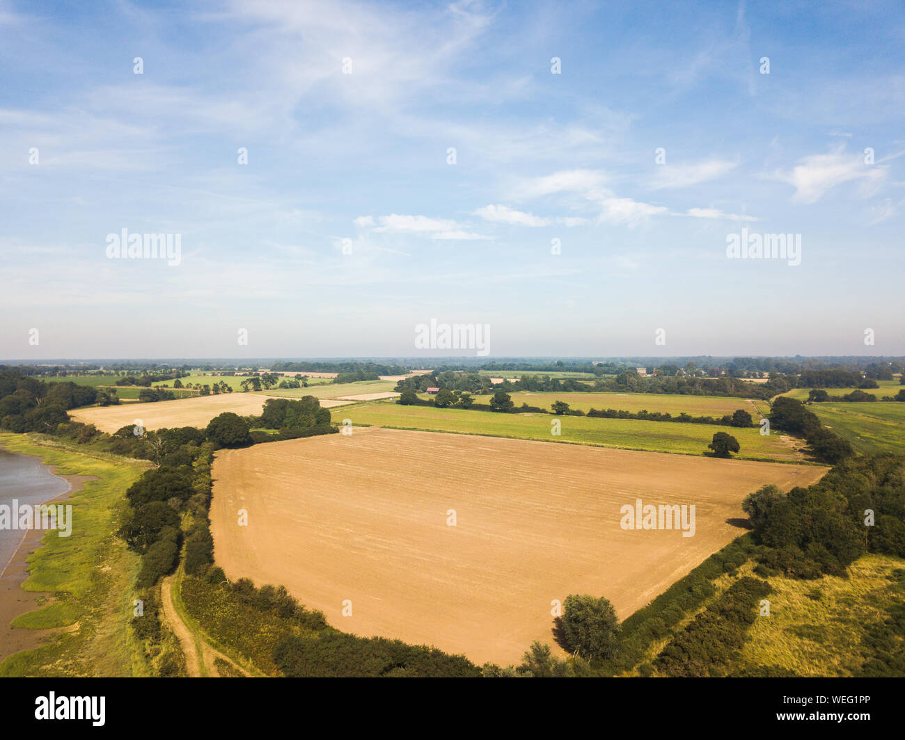 Aerial view of the Suffolk countryside with a recently harvested hay ...