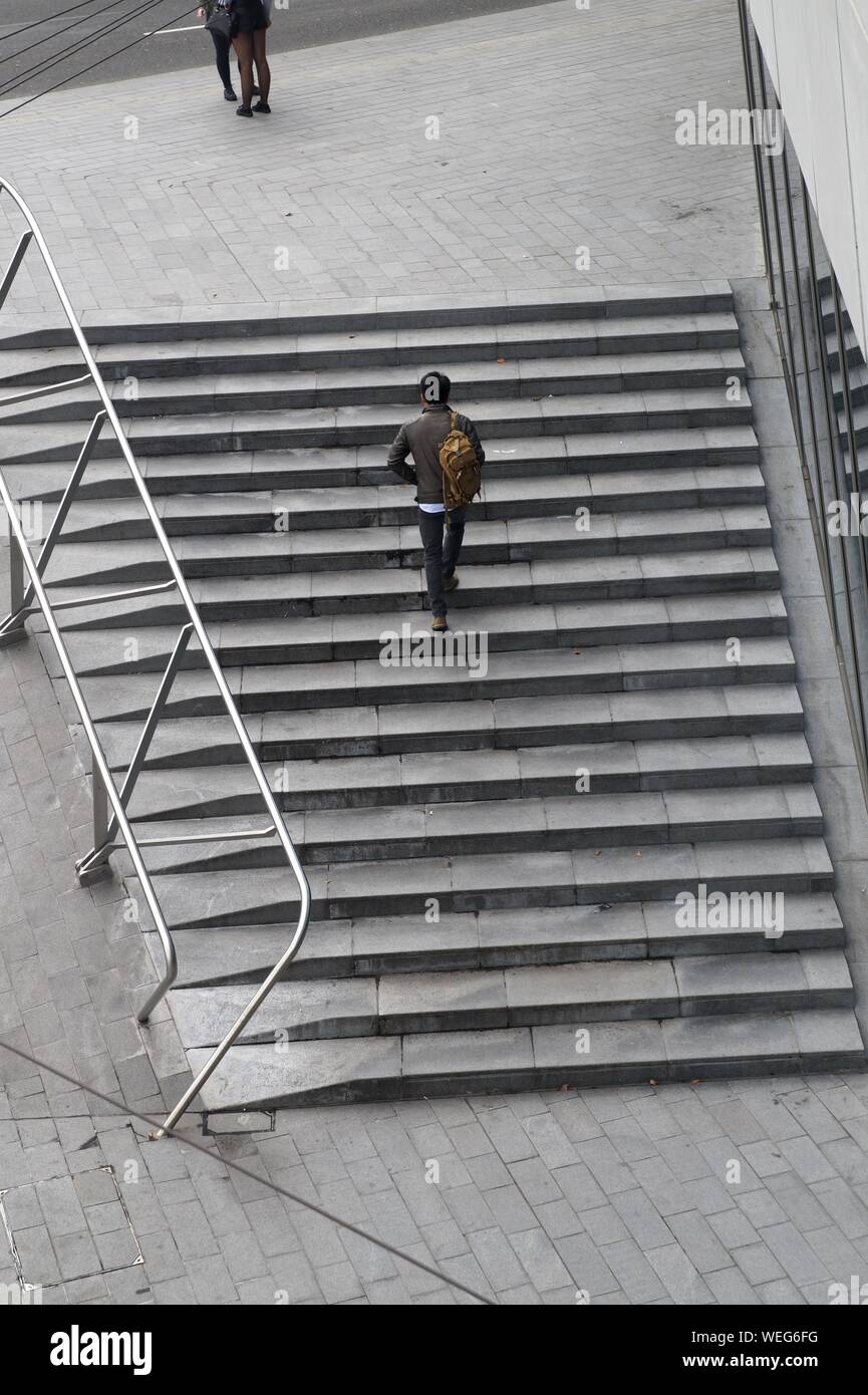 Man walking up steps hi-res stock photography and images - Alamy