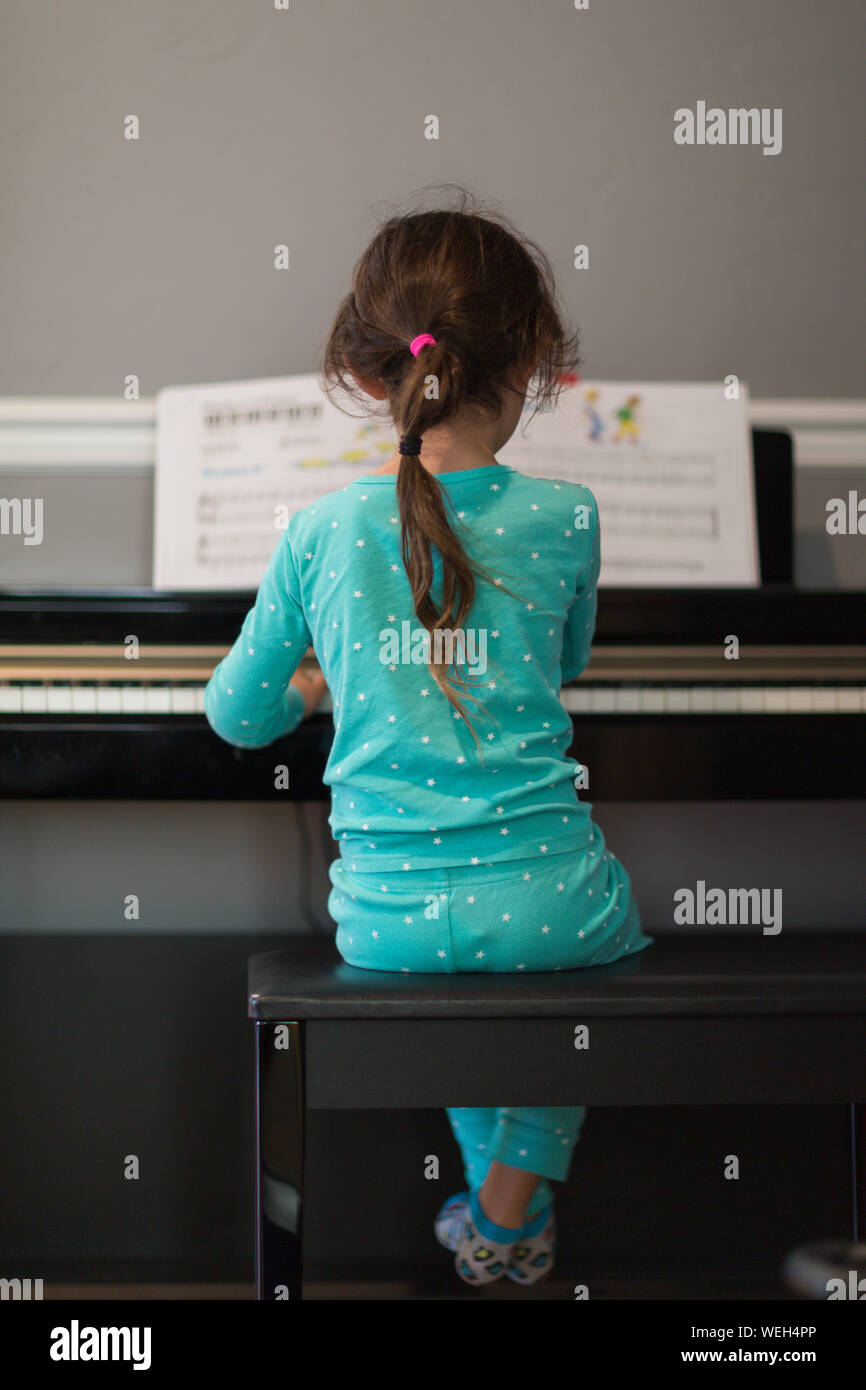 Young mixed ethnicity girl practicing piano, San Jose, California Stock ...