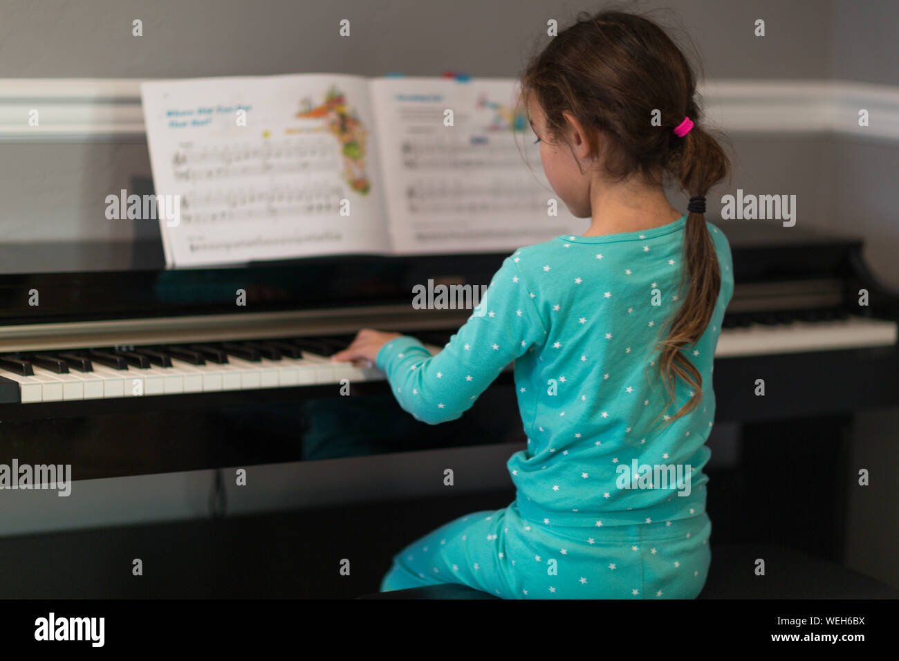Young mixed ethnicity girl practicing piano, San Jose, California Stock ...
