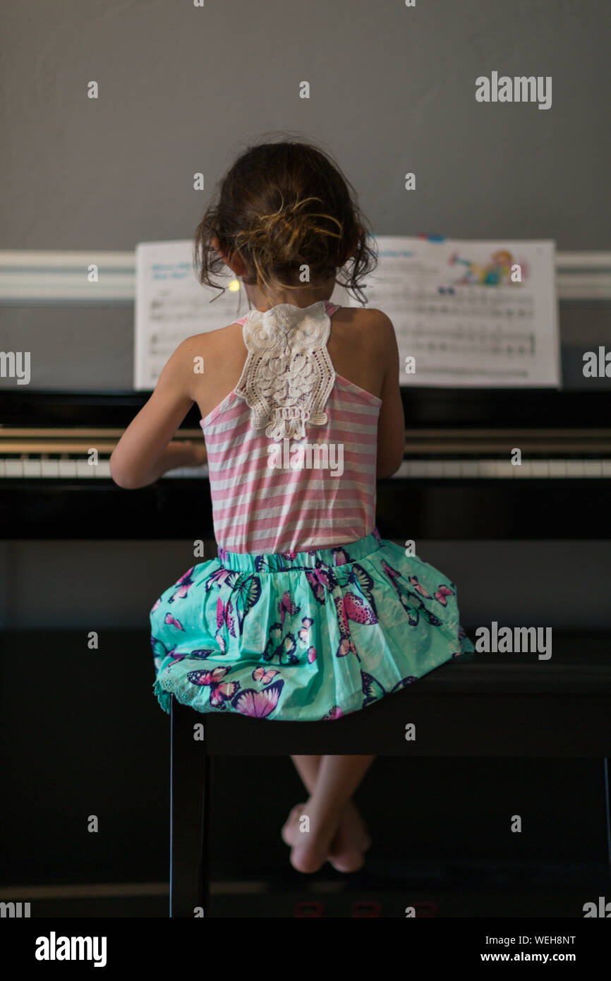 Young mixed ethnicity girl practicing piano, San Jose, California Stock ...