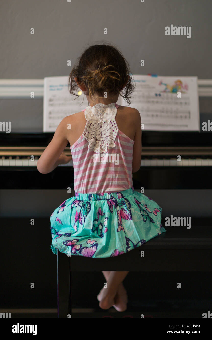 Young mixed ethnicity girl practicing piano, San Jose, California Stock ...