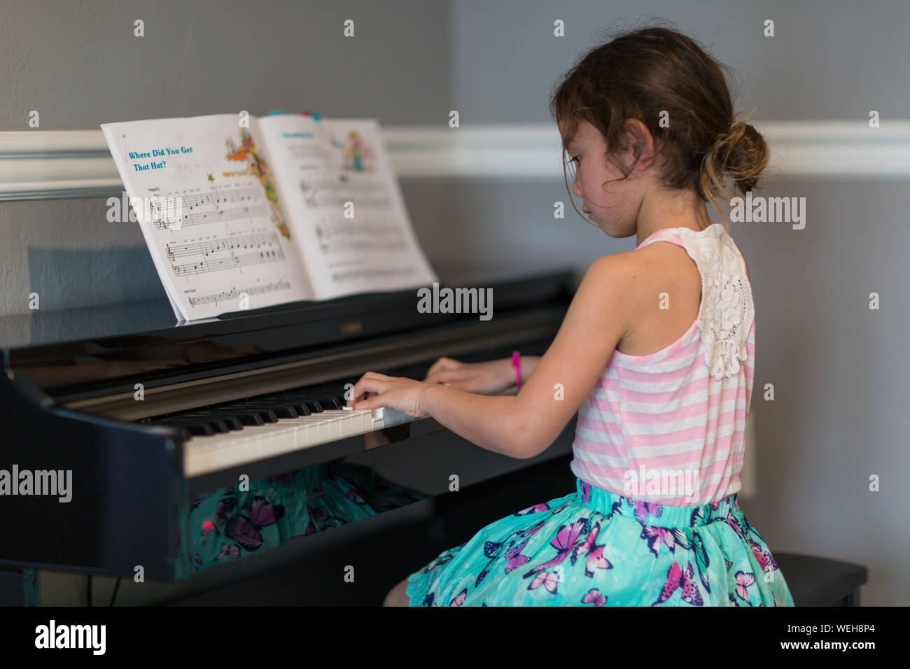 Young mixed ethnicity girl practicing piano, San Jose, California Stock ...