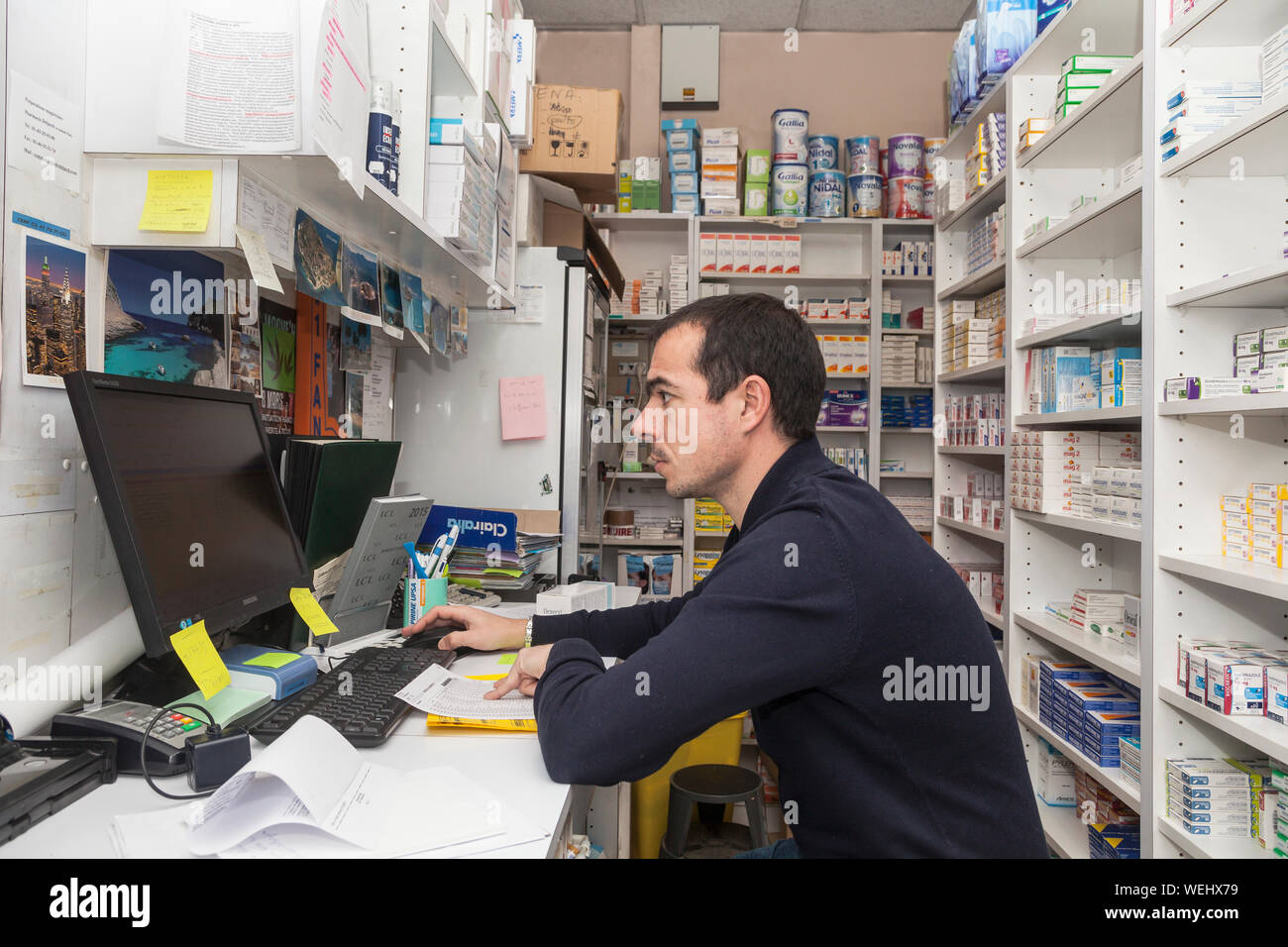 A pharmacist works at his desk in a pharmacy in Tours, France Stock ...