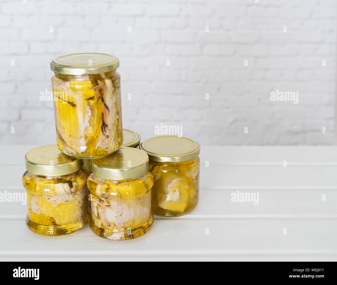 Tuna packed in glass jars on white background. Copy space Stock Photo ...