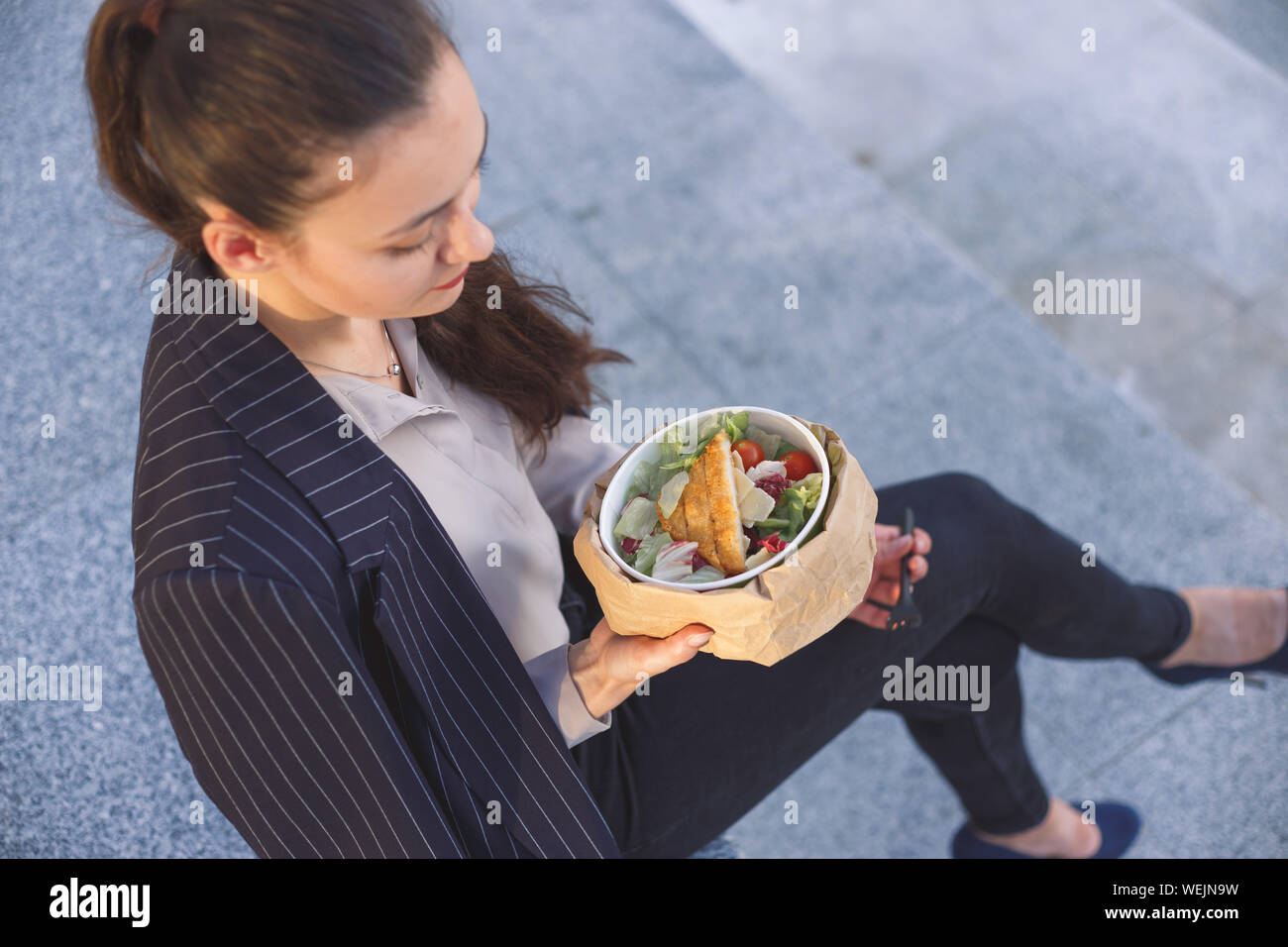 Woman eating outside the office hi-res stock photography and images - Alamy