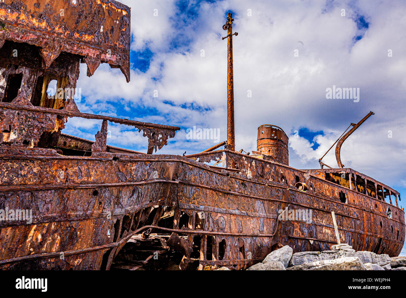 Blue sky with remains of ship wreck on the beach hi-res stock ...