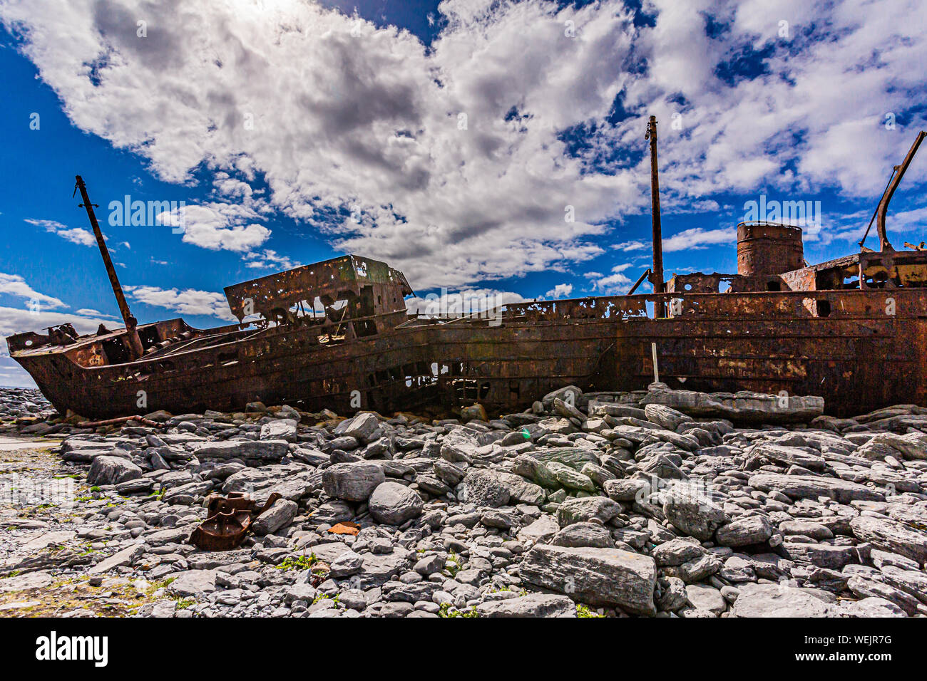 Rusty remains of ship wreck on blue beach hi-res stock photography and ...