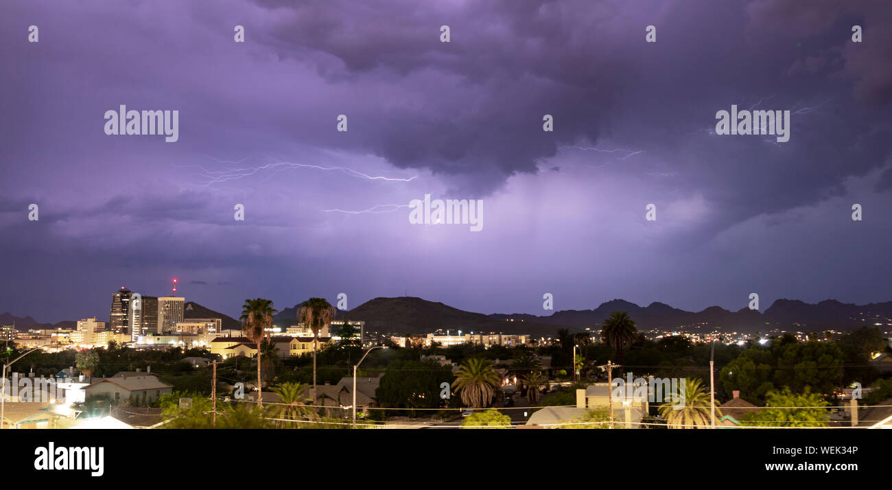 Purple Blue light illuminates the sky over the buildings homes and ...