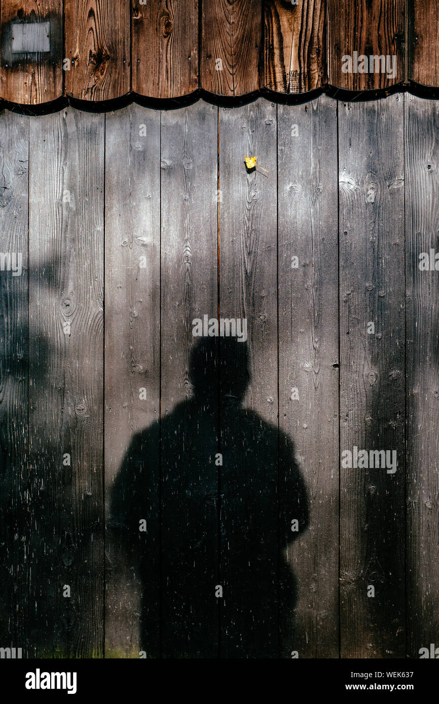 Shadow Of Person Falling On Wooden Wall Stock Photo - Alamy