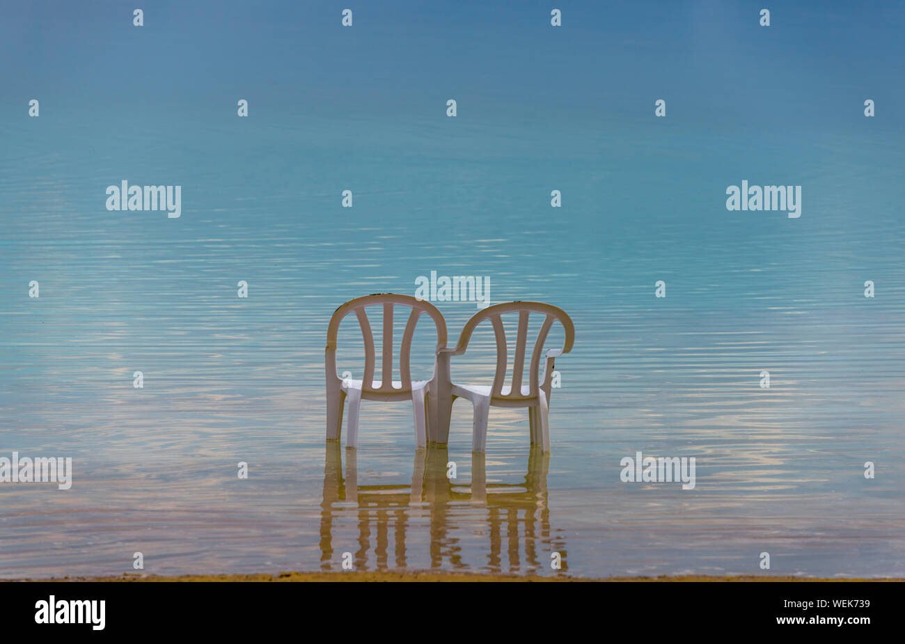 Plastic chairs at the Dead sea beach Stock Photo - Alamy