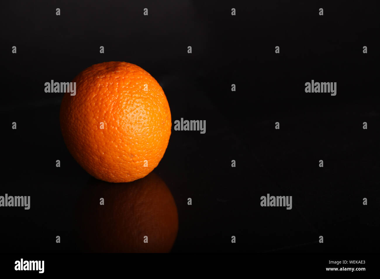 Low Key Orange Fruit isolated on black background with copy space Stock ...
