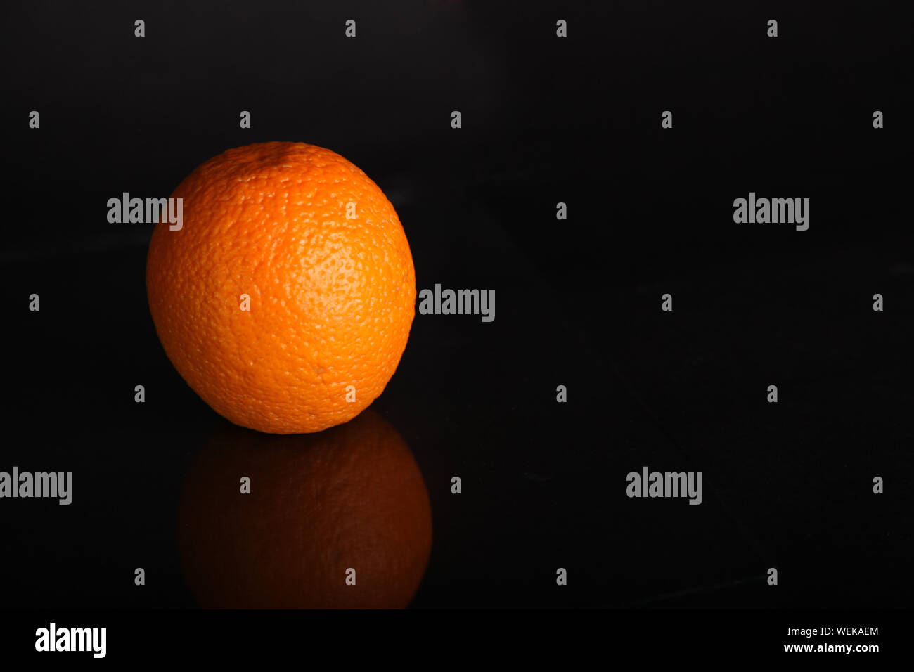 Low Key Orange Fruit isolated on black background with copy space Stock ...