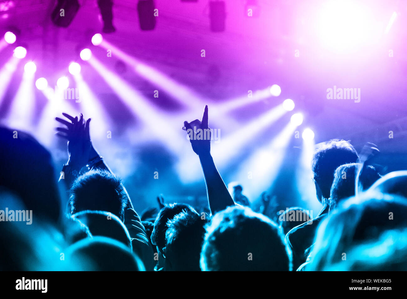Colourful concert hall with clapping people Stock Photo - Alamy