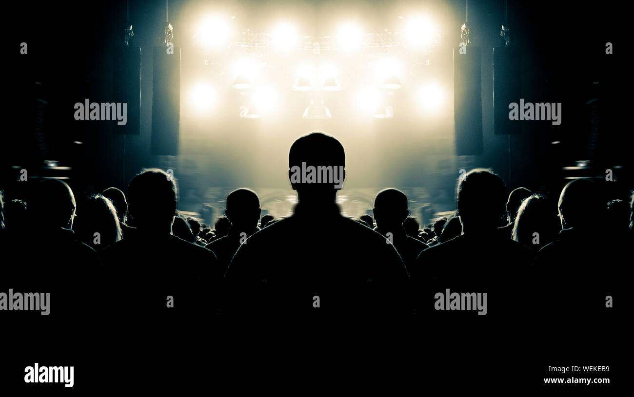 Colourful concert hall with clapping people Stock Photo - Alamy