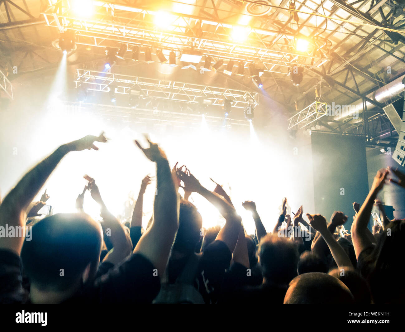 Colourful concert hall with clapping people Stock Photo - Alamy