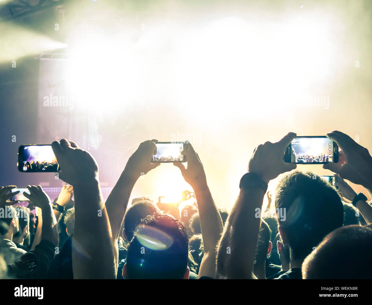 Colourful concert hall with clapping people Stock Photo - Alamy