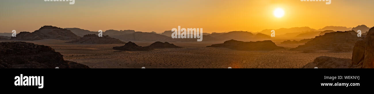 A panorama picture of Wadi Rum's landscape at sunset Stock Photo - Alamy