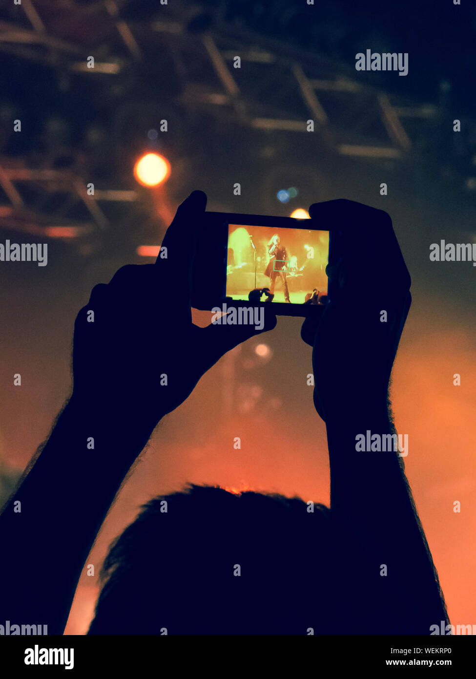 Colourful concert hall with clapping people Stock Photo - Alamy