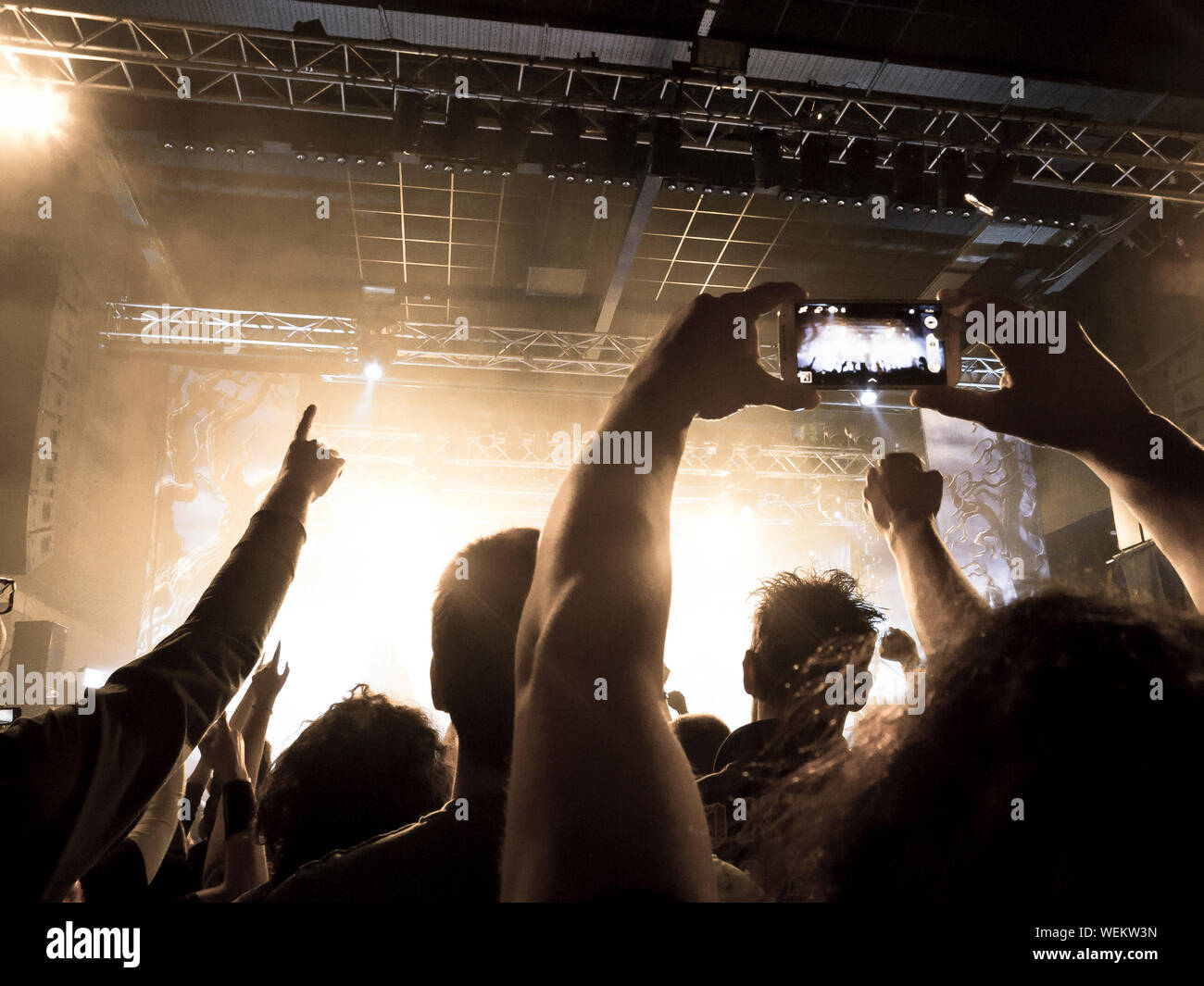 Colourful concert hall with clapping people Stock Photo - Alamy