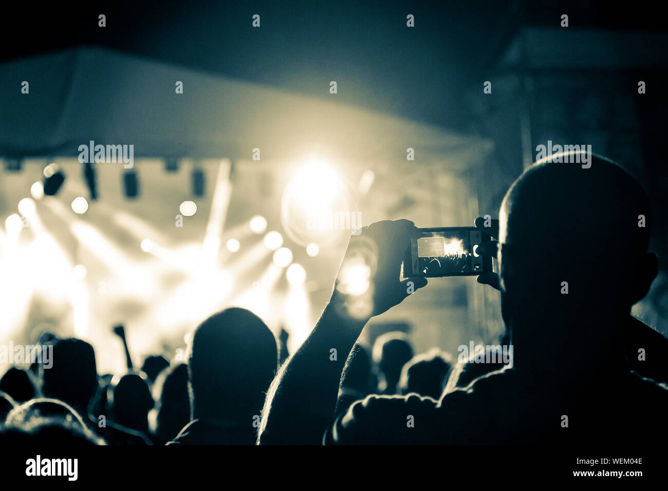 Colourful concert hall with clapping people Stock Photo - Alamy