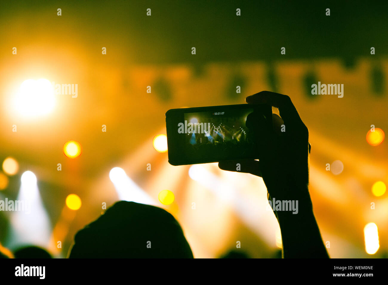 Colourful concert hall with clapping people Stock Photo - Alamy