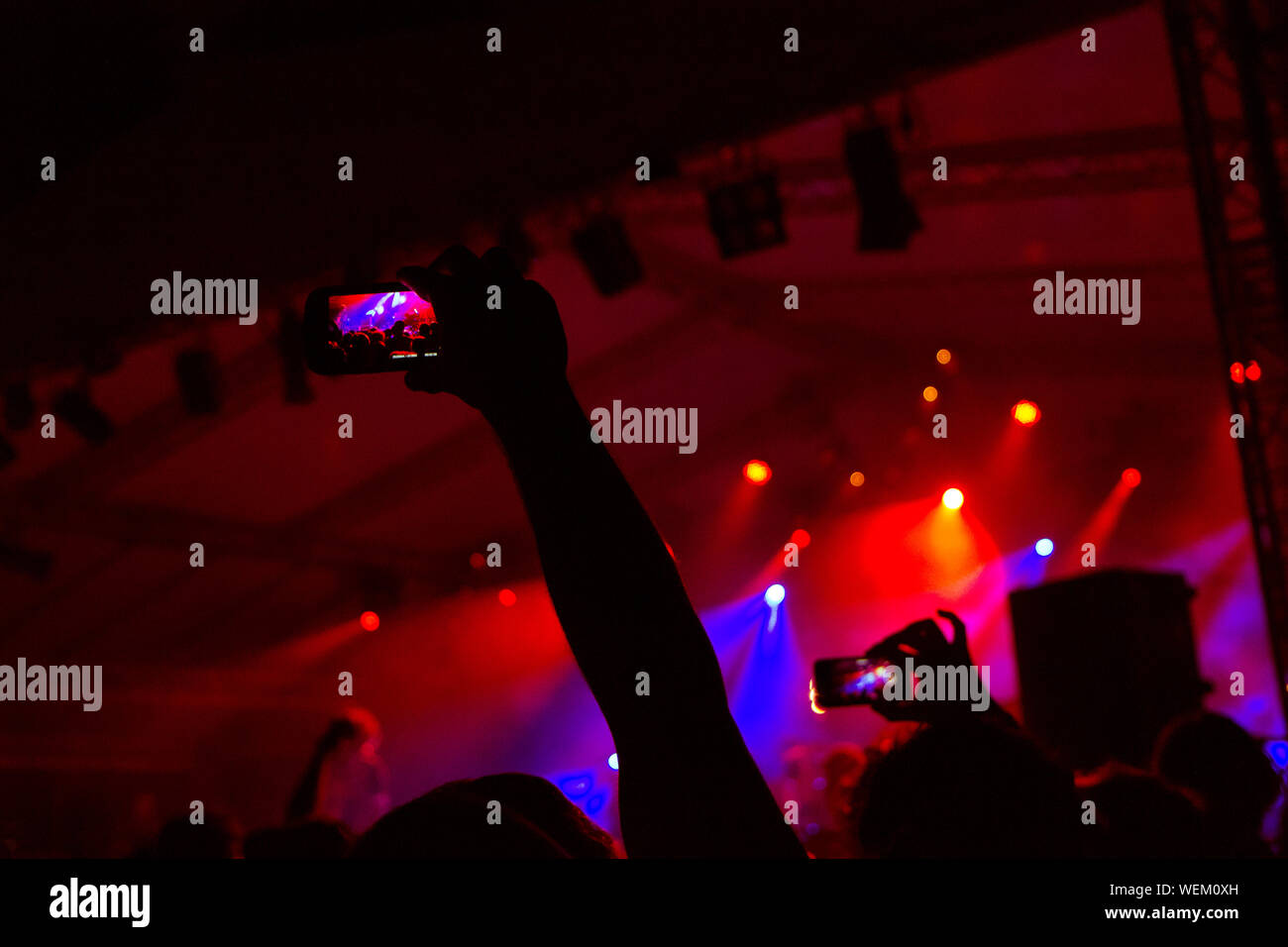 Colourful concert hall with clapping people Stock Photo - Alamy