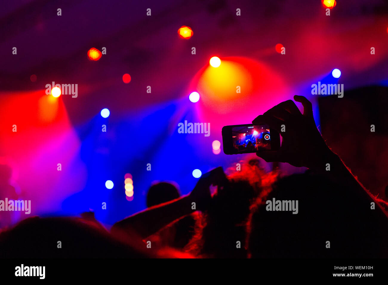 Colourful concert hall with clapping people Stock Photo - Alamy