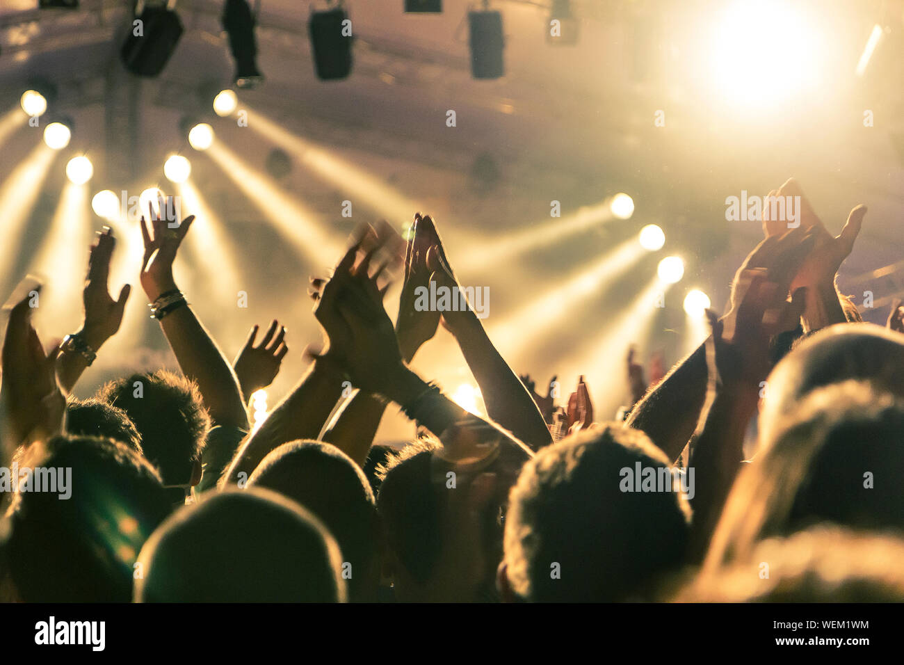 Colourful concert hall with clapping people Stock Photo - Alamy