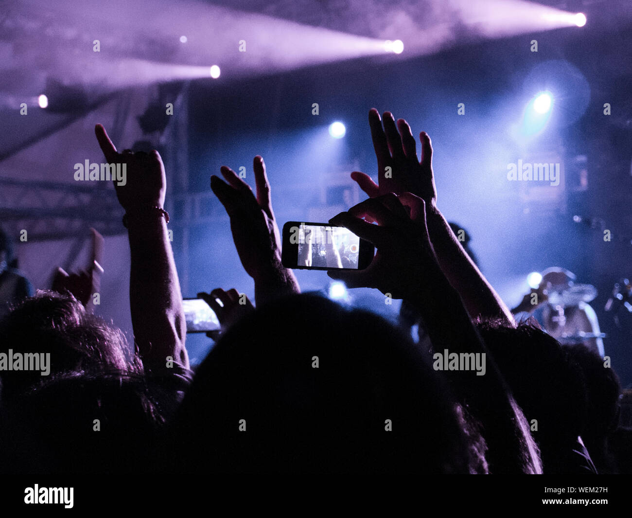 Colourful concert hall with clapping people Stock Photo - Alamy