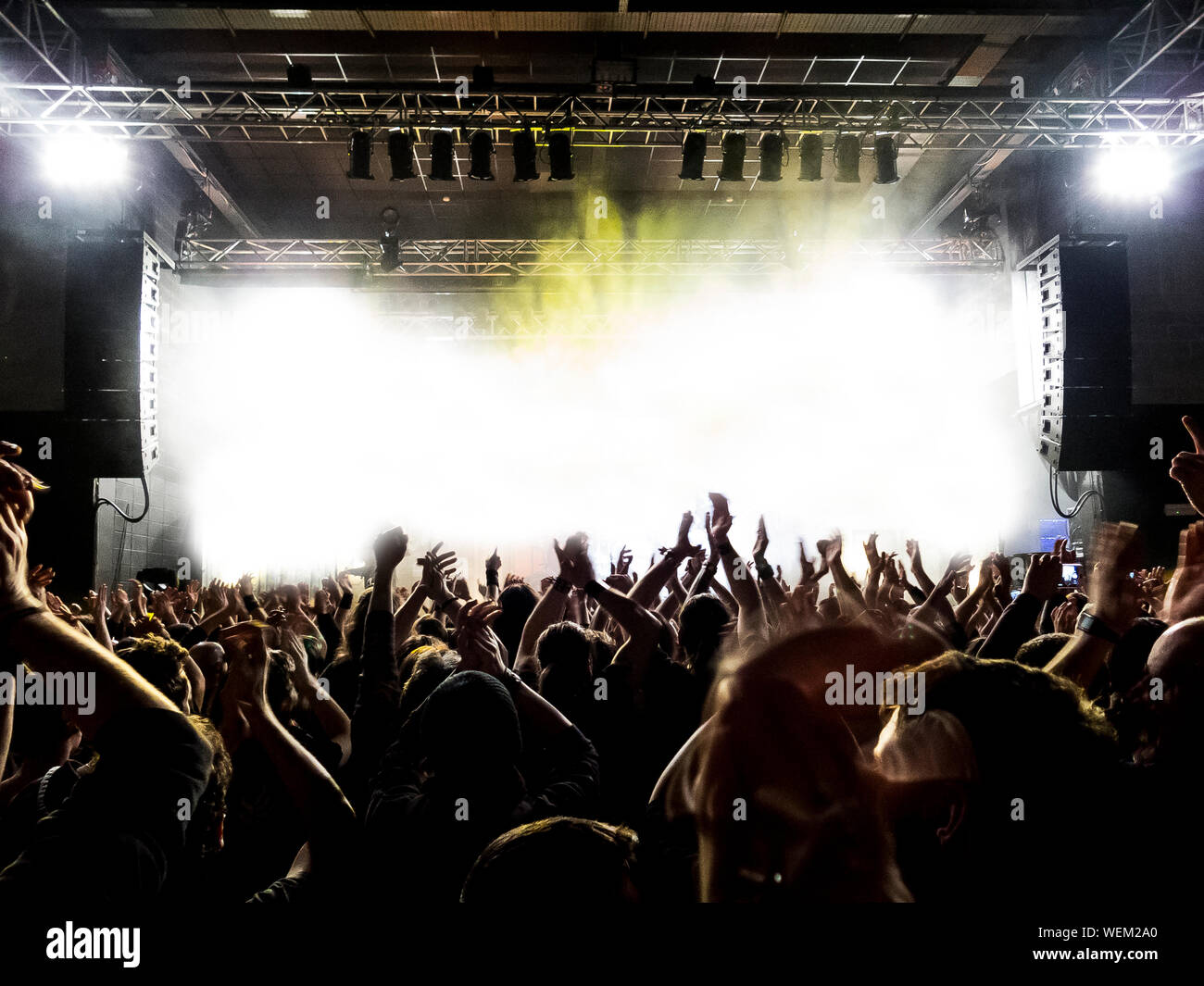 Colourful concert hall with clapping people Stock Photo - Alamy